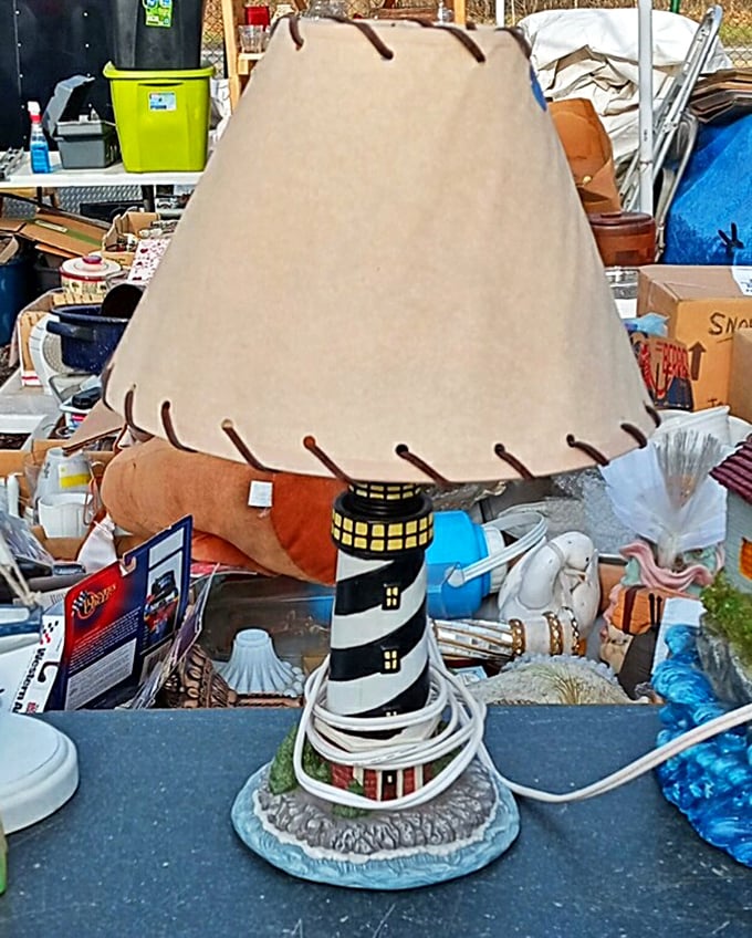 Lighthouse lamp illuminates a sea of treasures. This nautical nightlight would make any coastal-themed room captain shout "land ho!"