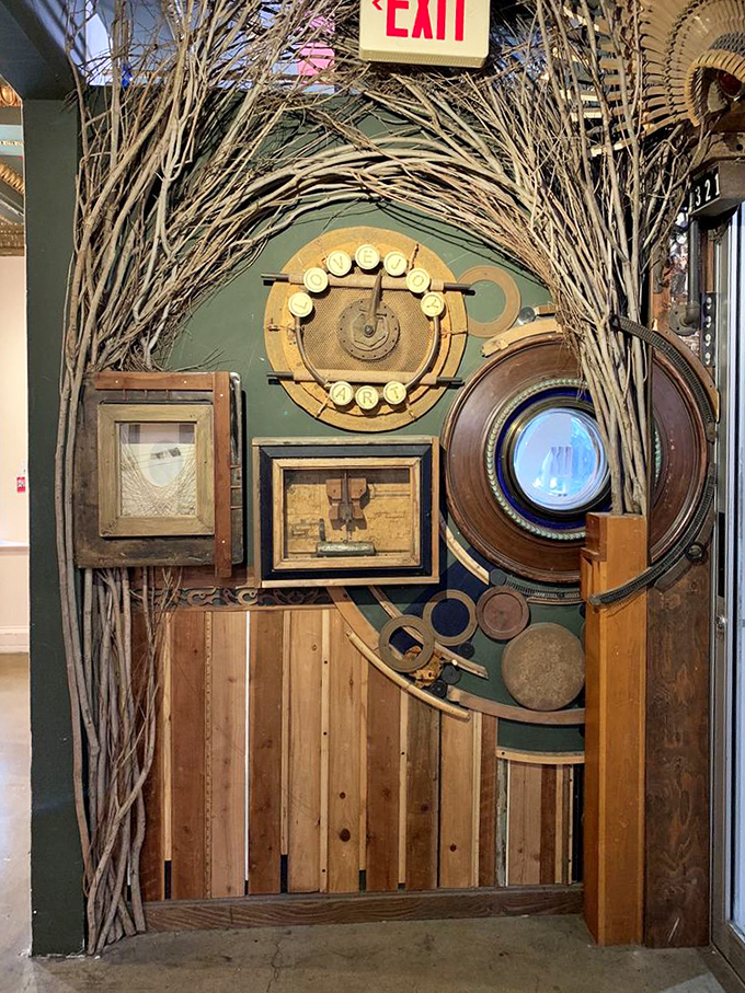 An archway of twisted branches frames mechanical curiosities. Alice would approve of this wonderland portal between book worlds.
