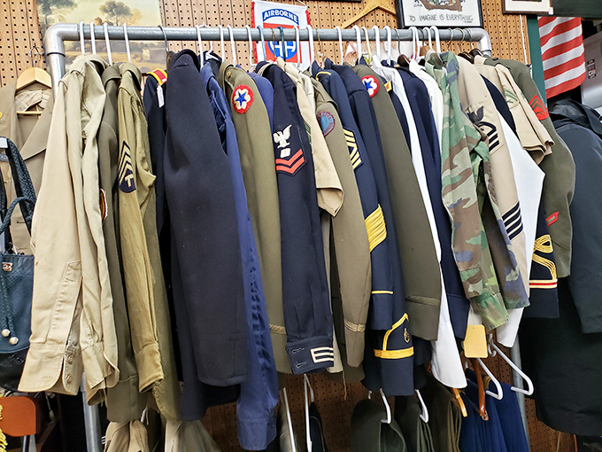 Military uniforms standing at attention, each with patches telling silent stories of service, sacrifice, and history beyond any museum display.