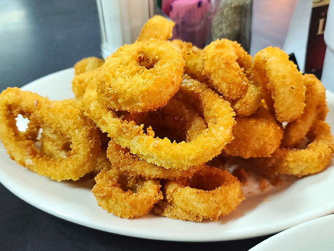 Golden rings of happiness stacked higher than a Texas tall tale. Crispy, not greasy&mdash;the mark of onion ring mastery.