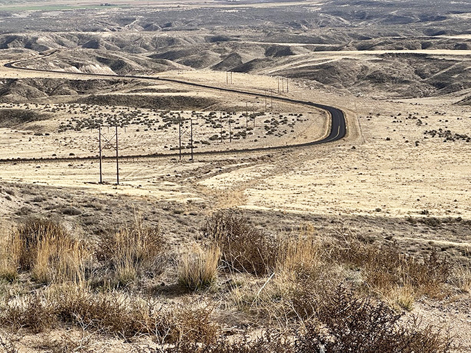 The winding road through Idaho's high desert landscape tells a silent story of pioneers who crossed this unforgiving terrain without GPS or air conditioning.