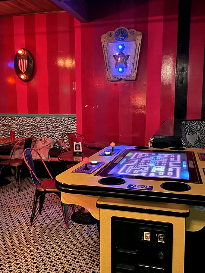 Even the arcade games upstairs maintain the striped theme, proving that at The Unicorn, no detail is too small for a splash of whimsy.