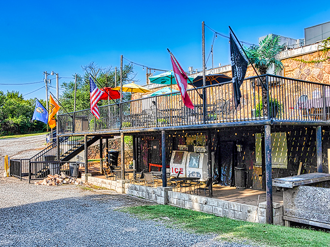 The Rock-A-Way Tavern flies its flags proudly, a colorful welcome to thirsty travelers seeking cold drinks and warm conversation.
