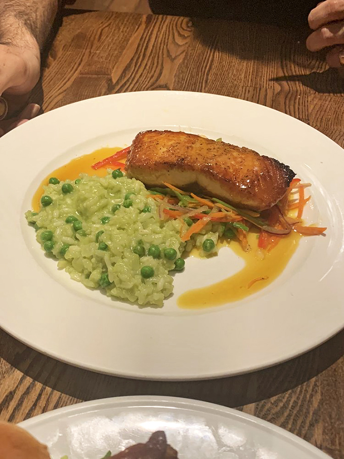 Pan-roasted salmon perched atop vibrant pea risotto proves Buckley's kitchen handles elegance as deftly as tavern classics.