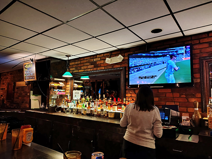 Sports on the screen, spirits on the shelf, and sliders on the way. The trifecta of happiness in one cozy corner.