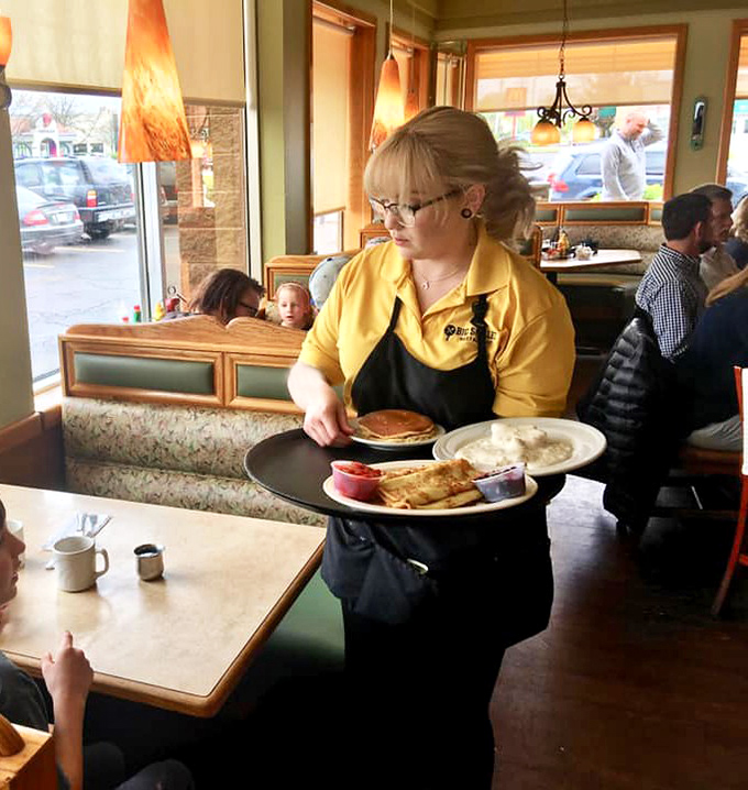 The true heroes of breakfast wear yellow shirts and carry plates stacked with pancakes like Olympic torches of morning glory.