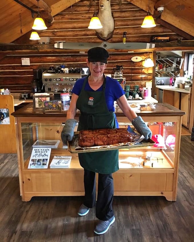 Fresh-baked cinnamon rolls emerge from the kitchen like edible trophies. The smile says it all&mdash;this is food made with genuine joy.