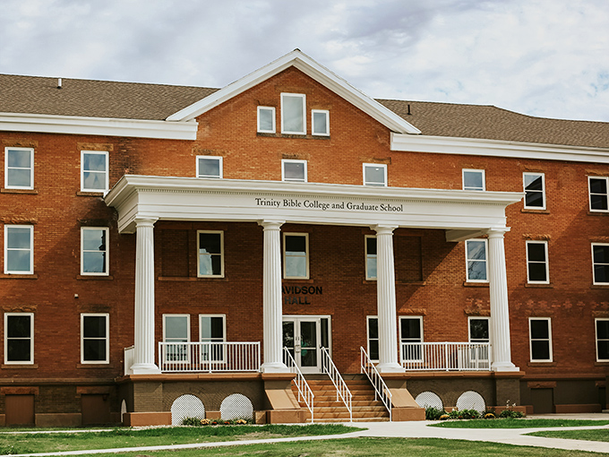 Trinity Bible College's impressive brick facade and columned entrance bring classical architectural grandeur to the prairie landscape of Ellendale.