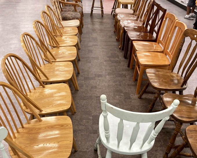 The wooden chair convention, where oak meets opportunity. That lone white chair seems to be making a statement among its honey-toned neighbors.