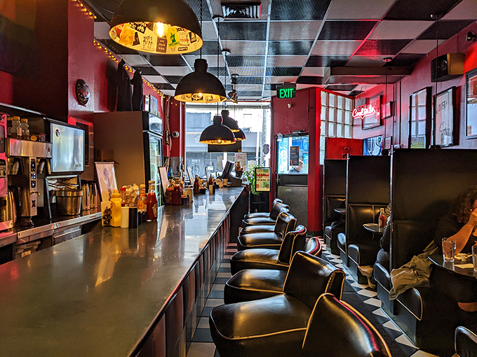 The warm glow of pendant lights transforms this diner into a Edward Hopper painting with better food options.