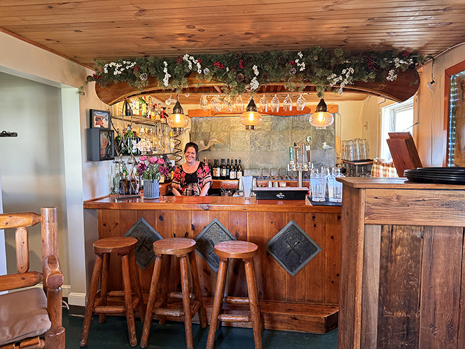 The bar area feels like the coolest corner of a friend's lake house – warm wood, twinkling lights, and the promise of excellent drinks.