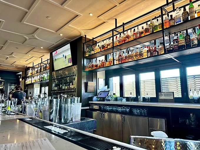 The bar stretches invitingly with bottles lined up like soldiers, ready to serve whatever helps you forget about Monday.