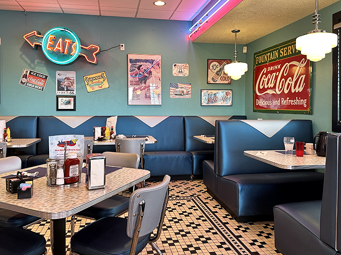 Booths bathed in neon glow under the watchful eye of an "EAT" sign that's never given bad advice.