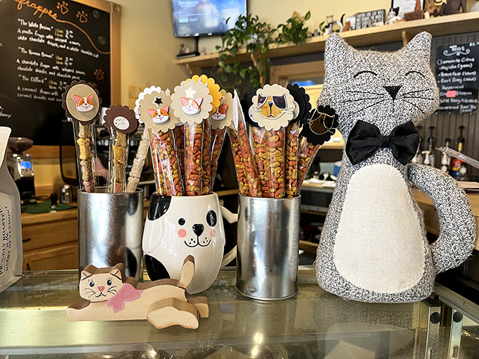Whimsical cat-shaped treat holders and pretzel sticks create an irresistible display that's almost too cute to disturb.