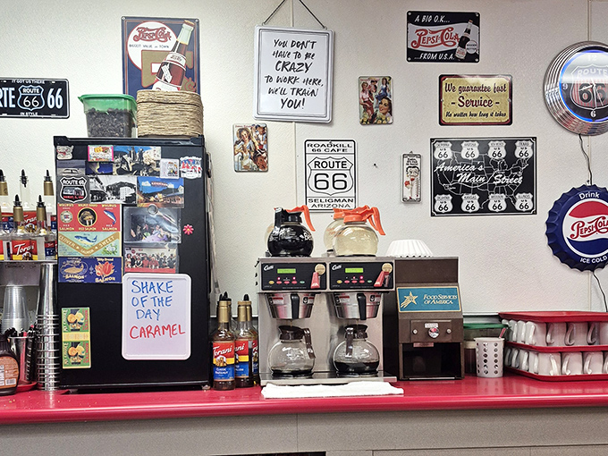 The coffee station wall&mdash;a shrine to caffeine, nostalgia, and the unwritten rule that diners must display more signs than a highway department.