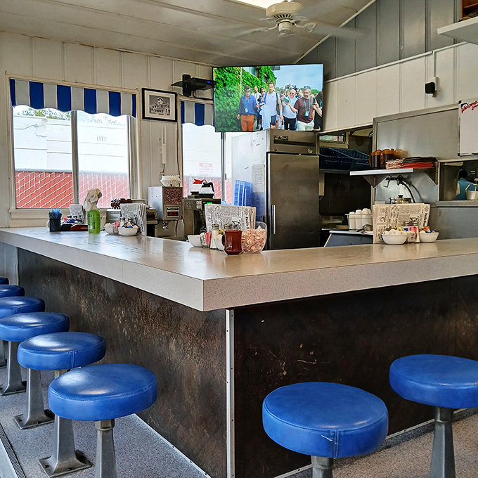 The counter—where solo diners find community, regulars claim their territory, and those blue stools have supported generations of San Pedro residents.
