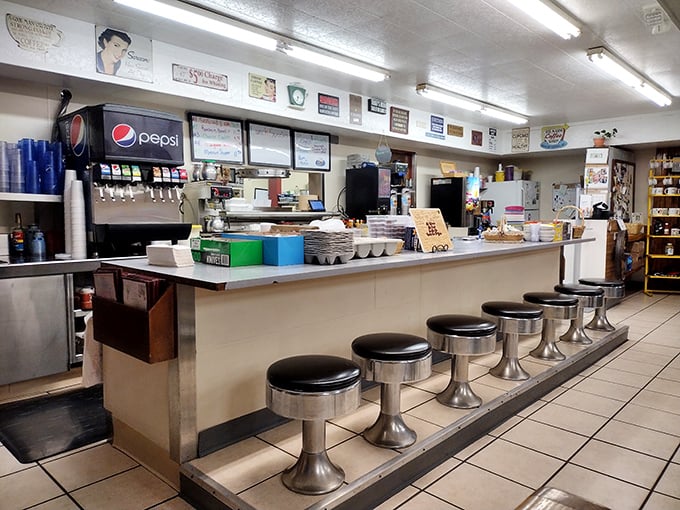 Classic counter seating where regulars perch like birds on a wire, watching the choreography of short-order cooking while nursing endless coffee refills.