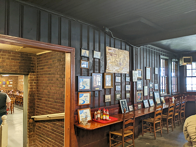 Wall-to-wall memories frame simple wooden tables where generations have left nothing but clean plates and satisfied smiles.