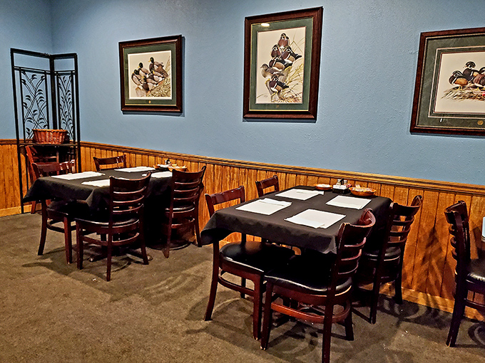 Duck prints on blue walls above wooden wainscoting&mdash;a dining room that says "Yes, we take our steaks seriously, but we don't take ourselves too seriously."