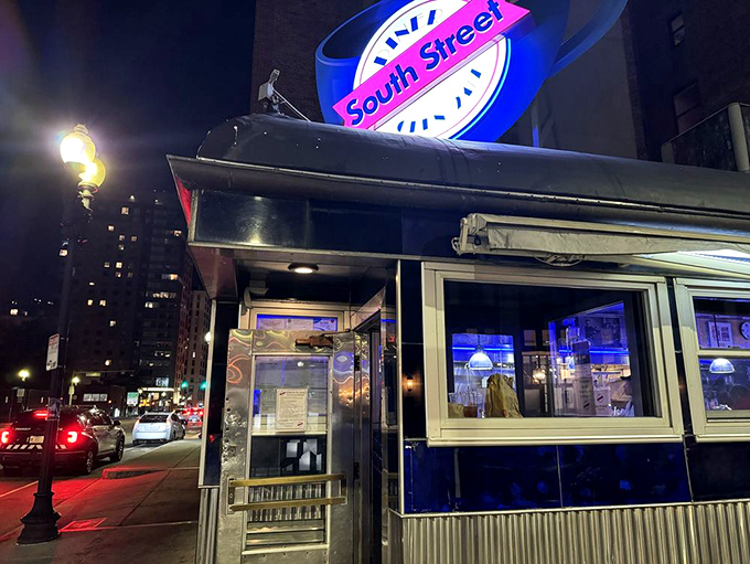Night falls, but the diner's glow never dims&mdash;a 24-hour lighthouse guiding hungry travelers through Boston's after-dark landscape.