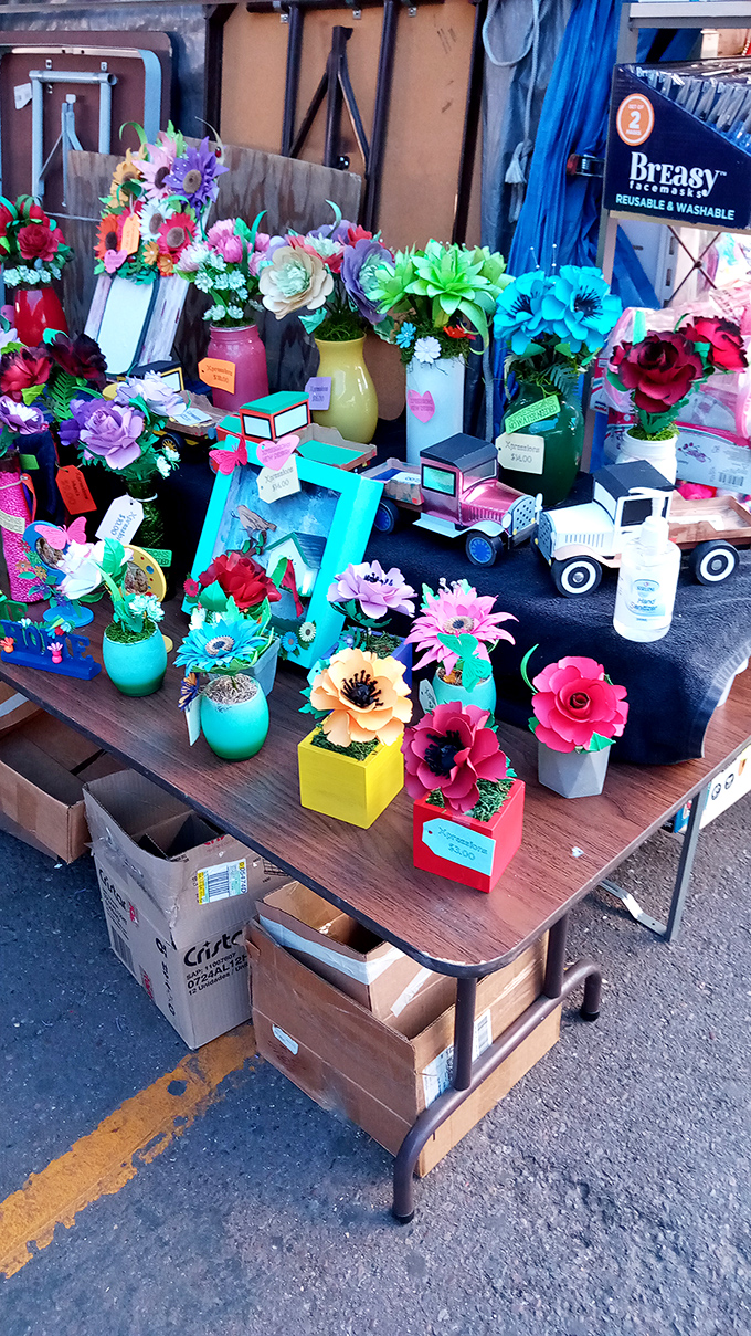 Artificial flowers that never wilt bring perpetual spring to desert homes. These colorful arrangements offer drought-resistant cheer in vibrant turquoise vessels.
