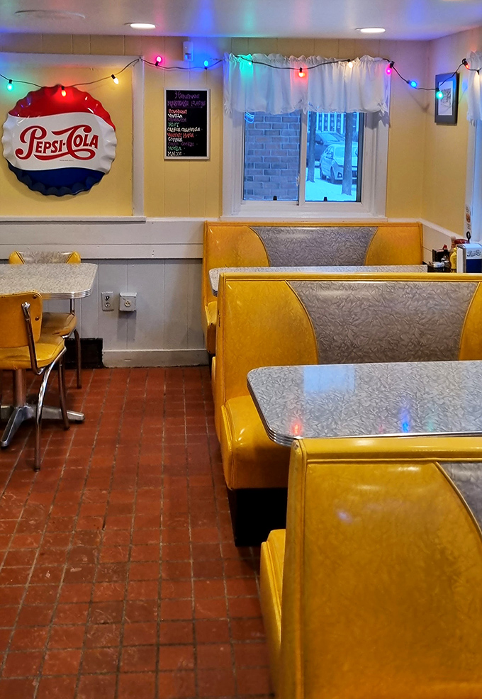 Classic diner booths in sunshine yellow, where the vinyl has been polished by generations of Vermonters sliding in for their morning coffee fix.