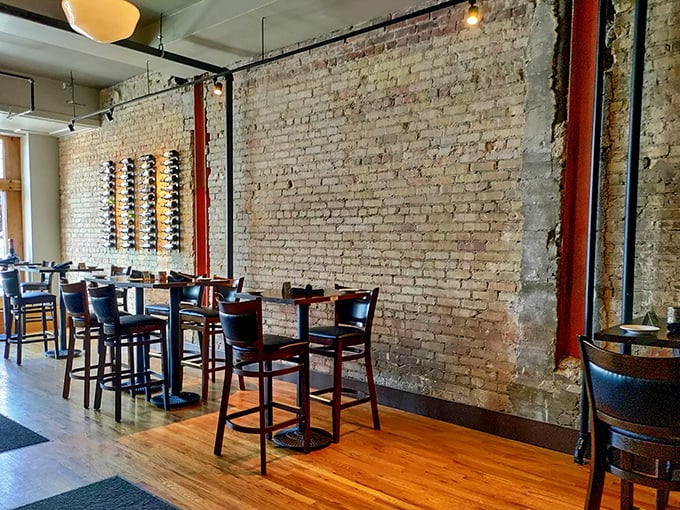 The bar seating area where exposed brick and wine racks create the perfect backdrop for that "I've discovered something special" feeling.