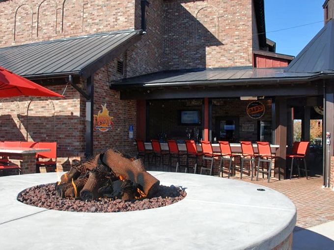The outdoor fire pit isn't just for show&mdash;it's foreshadowing the wood-fired delights awaiting inside. Those red chairs are practically begging you to sit down.
