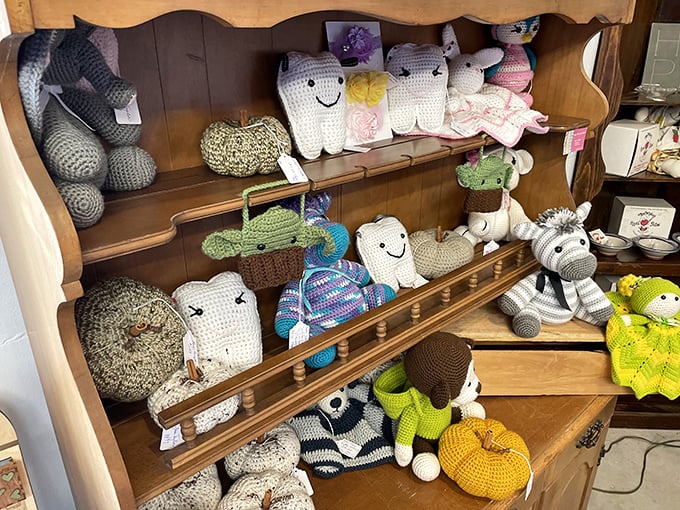 Handcrafted plushies add whimsy to the farm store experience. These smiling creations make perfect companions for the littlest apple pickers.