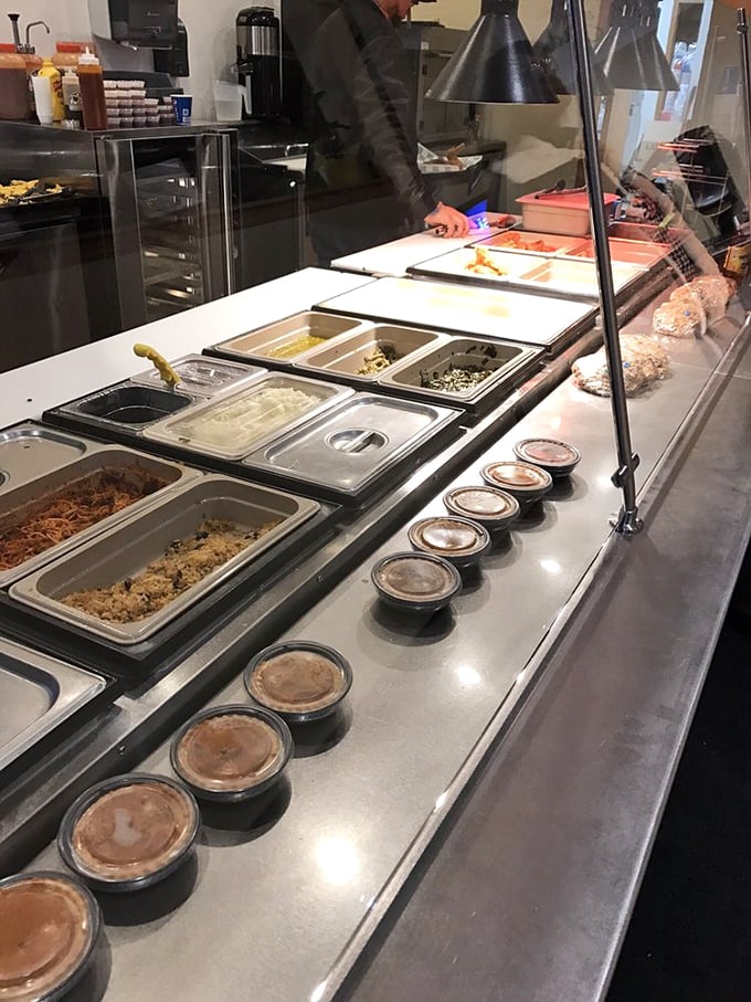 Behind the scenes where comfort food dreams come true. The prep line reveals an array of sides waiting to complement that perfect piece of chicken or fish.