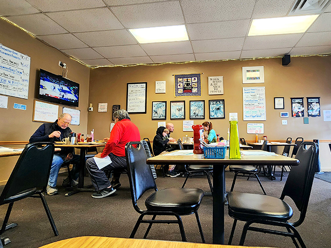 The dining room where strangers become temporary breakfast companions. Simple tables, comfortable chairs, and a TV that nobody's really watching.
