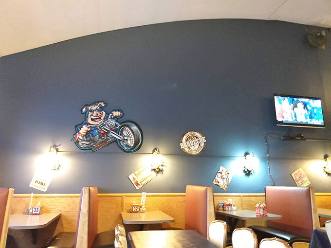 Blue walls and wooden booths create intimate dining zones where serious meat consumption can occur without judgment or interruption.