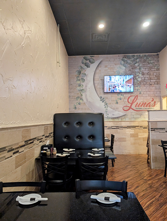 Cozy booth seating where the moon-themed wall art reminds you that Luna isn't just a name&mdash;it's a vibe.