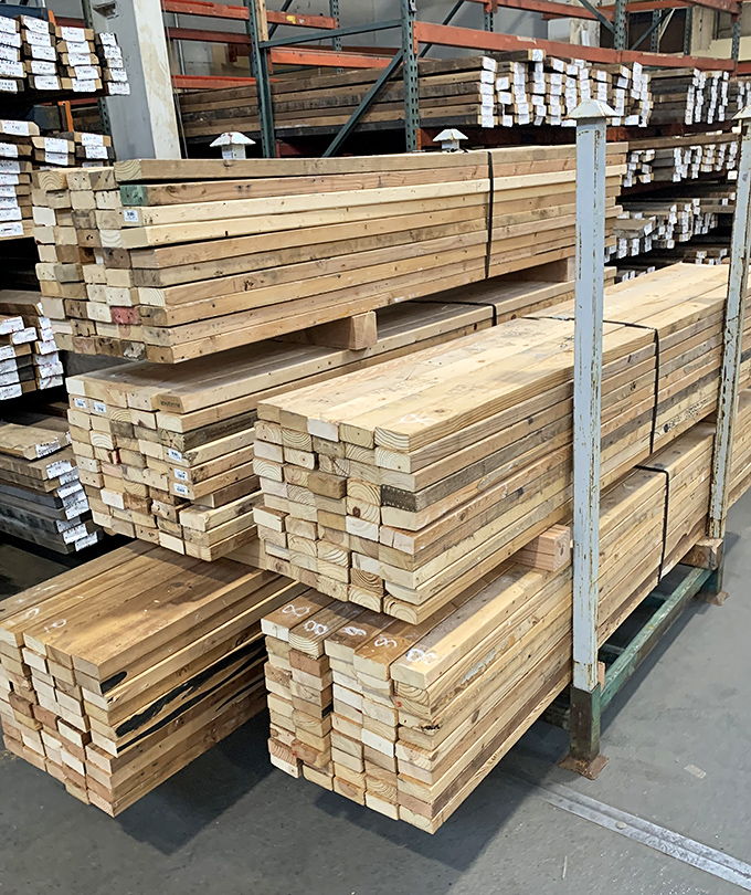Construction materials with stories to tell. These reclaimed lumber stacks represent forests saved and projects waiting to happen.