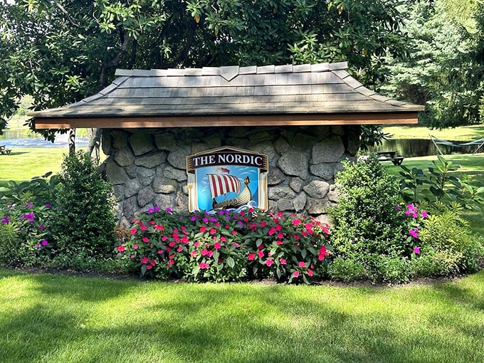 The entrance sign announces itself with Viking confidence, surrounded by flowers that are clearly thriving on a steady diet of prime rib drippings.