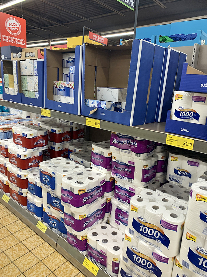 Paper products stacked with German precision. Even toilet paper shopping becomes an exercise in efficiency and savings at ALDI.