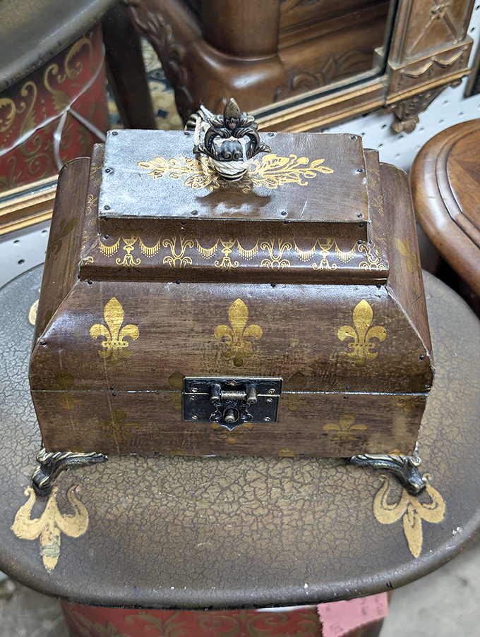 This ornate box with fleur-de-lis detailing once held someone's precious treasures—now it awaits yours, with stories already built into its brass hinges.