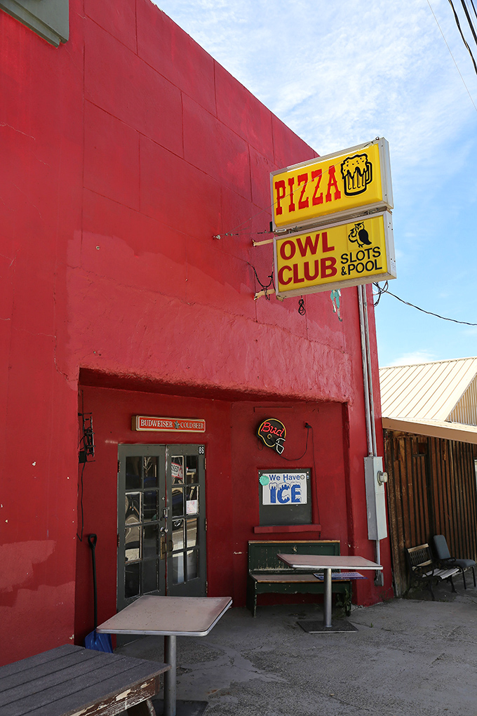 The Owl Club's blazing red exterior promises pizza, pool, and the simple pleasures of small-town Nevada nightlife.