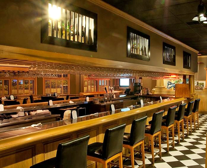 A bar that understands its purpose – well-stocked, well-lit, and designed for both serious drinking and casual conversation before dinner.