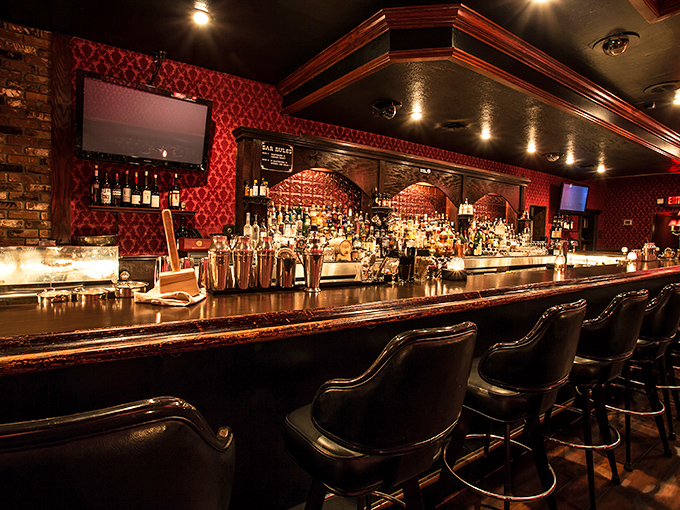 The bar isn't just stocked; it's a liquid library of rare spirits where mixologists craft cocktails with the precision of Swiss watchmakers.