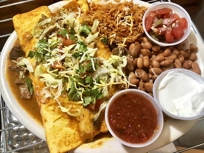 These enchiladas aren't just covered in cheese&mdash;they're tucked in under a blanket of it. The beans and rice aren't sides; they're supporting actors deserving their own award.