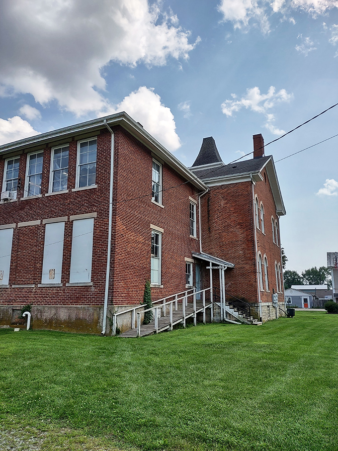 The sturdy brick schoolhouse represents an era when education was a community cornerstone and classrooms housed multiple grade levels.