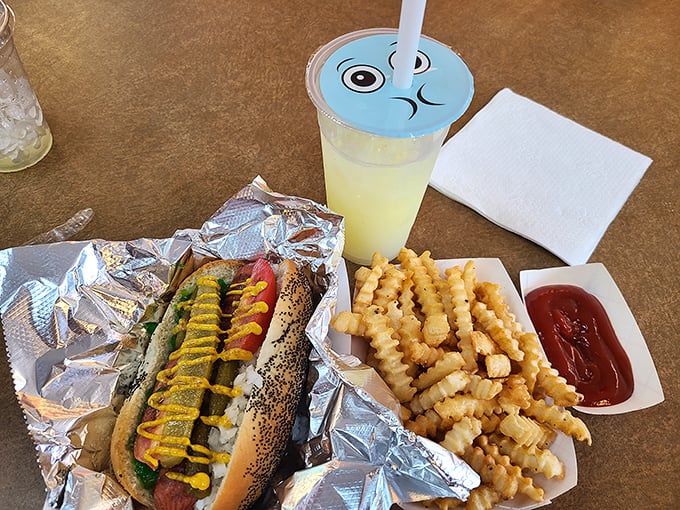 The complete experience: hot dog, fries, and a drink with a whimsical lid. Childhood joy meets grown-up hunger in perfect harmony.