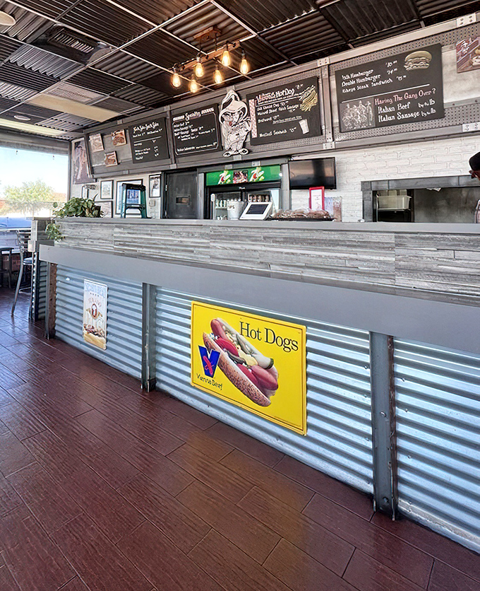 The counter where sandwich dreams come true. That corrugated metal front isn't just design – it's armor protecting Chicago culinary traditions in foreign territory.