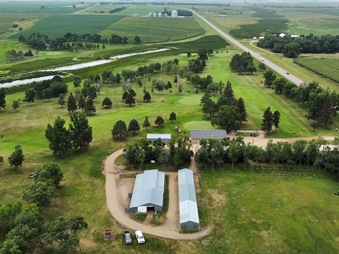 The Country Club stretches across the rolling landscape, where golfers chase little white balls through perfectly maintained greens surrounded by North Dakota's agricultural bounty.