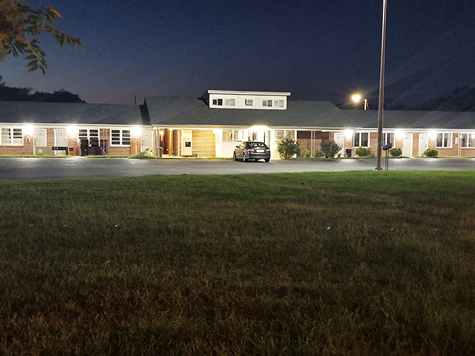 As evening falls, the Darlington Motel lights up with the warm glow of hospitality, offering weary travelers a no-frills place to rest their heads.