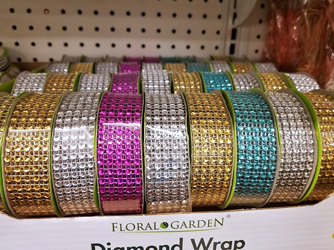 Diamond wrap rolls gleaming with possibility. Turning ordinary packages into gifts that look like they cost ten times more.