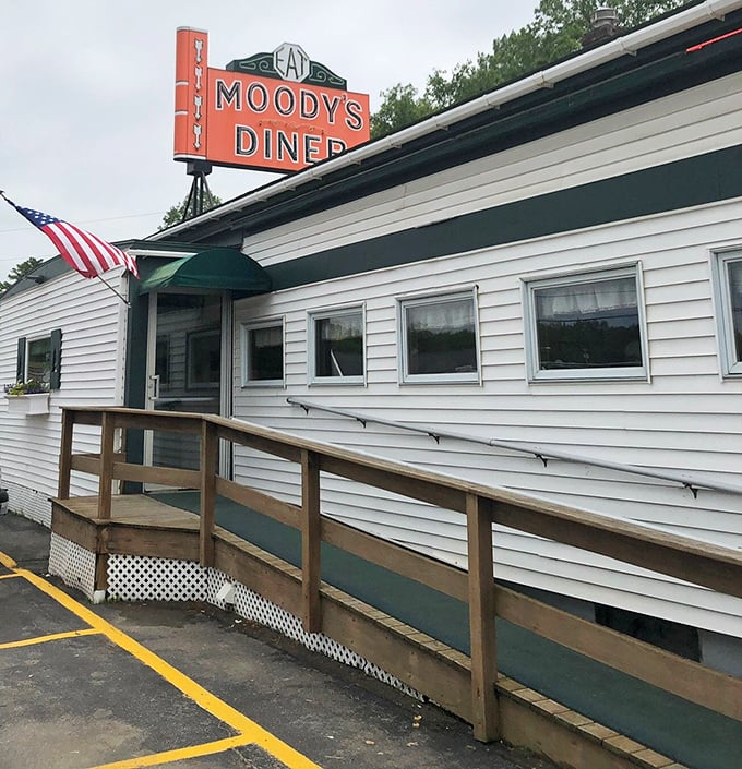 A humble entrance to extraordinary flavors. The American flag and green awning welcome visitors to this Maine institution.