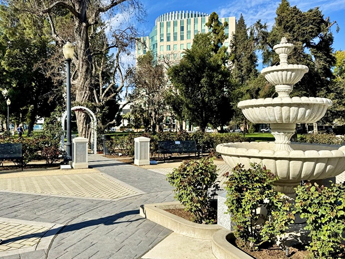 This classical fountain creates a soothing soundtrack for rose appreciation, its gentle splashing complementing the visual feast surrounding it.