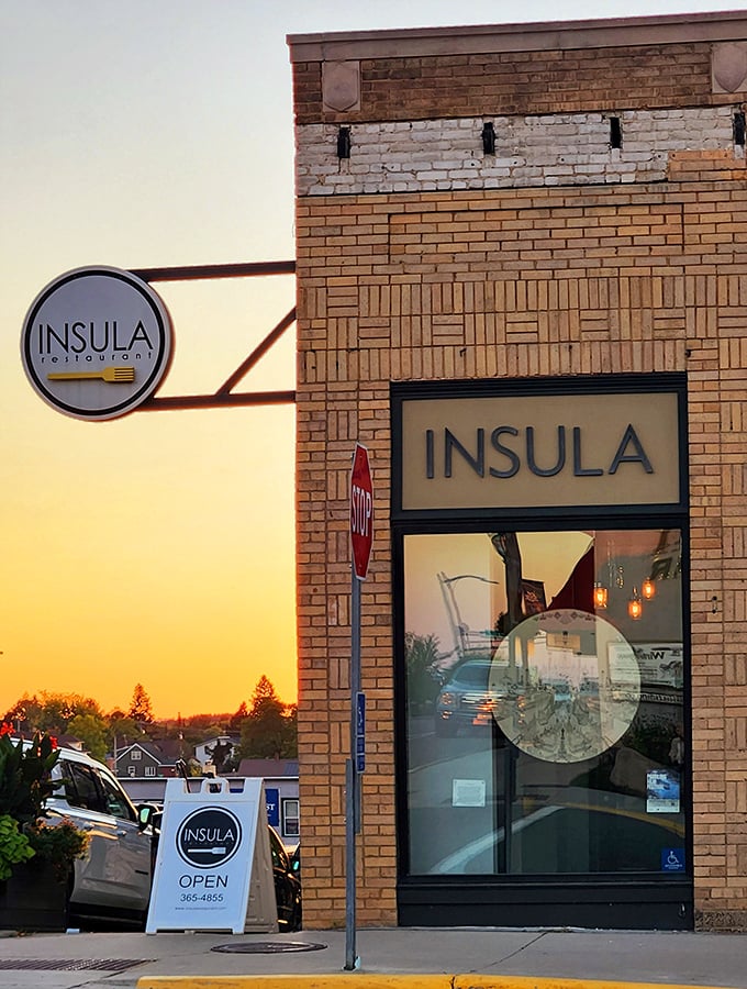 Insula Restaurant glows at sunset like a beacon for hungry adventurers. The golden light promises sophisticated dining in this surprisingly cosmopolitan wilderness town.